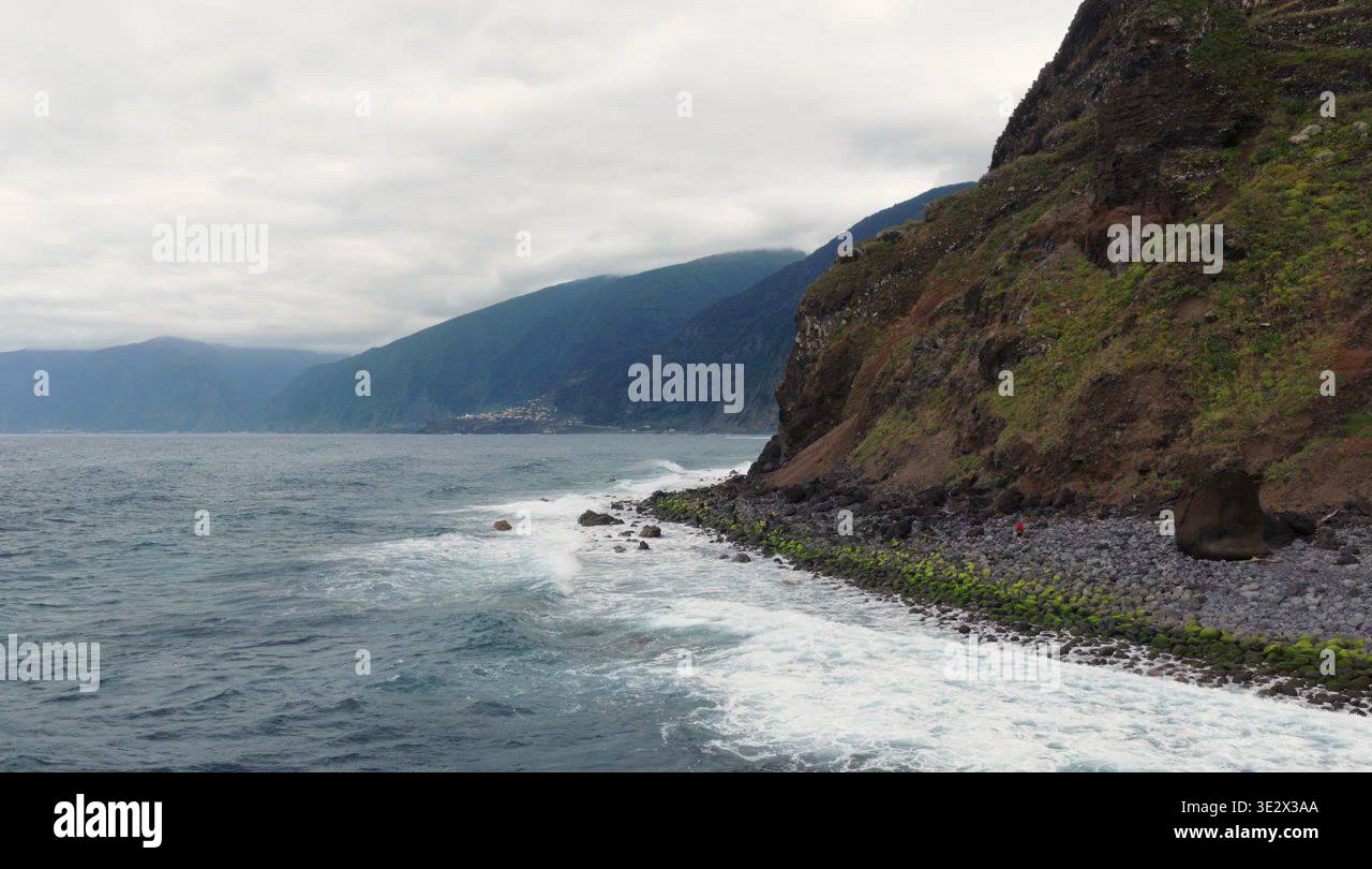 Dramatic volcanic sea stack off Madeira coast during cloudy weather ...
