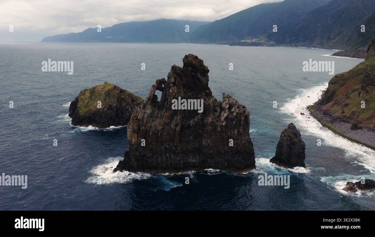 Dramatic volcanic sea stack off Madeira coast during cloudy weather ...