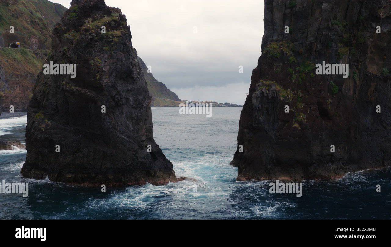 Dramatic volcanic sea stack off Madeira coast during cloudy weather ...