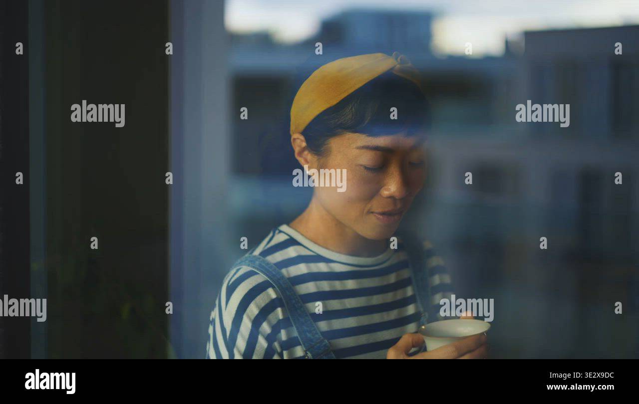 Asian woman enjoying hot tea at home Stock Video Footage - Alamy