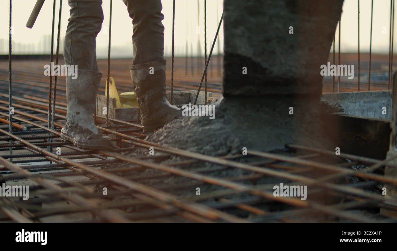 Pouring concrete over rebar mesh Stock Video Footage - Alamy
