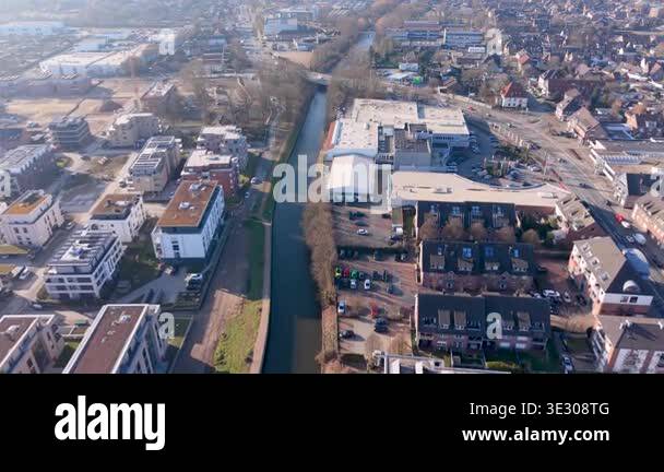 High angle aerial view of a narrow canal flowing through a modern ...