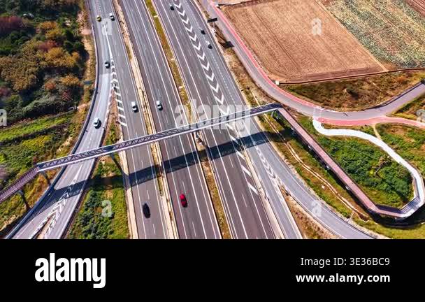 High angle view of pedestrian bridge over highway. Metallic walkway ...