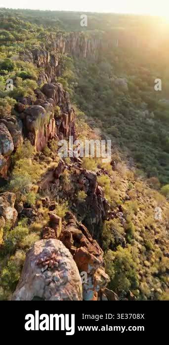 Aerial drone view of dramatic rocky cliffs and green vegetation in ...