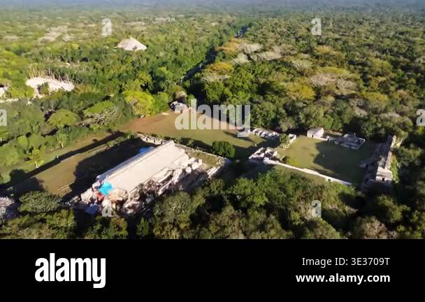 Aerial drone view over ancient Mayan temple structures hidden within ...