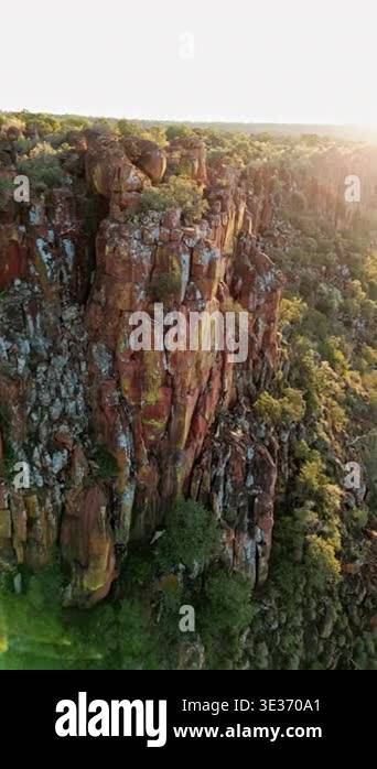 Aerial drone view of dramatic rocky cliffs and green vegetation in ...