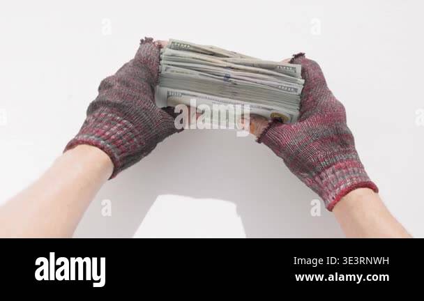 Poor homeless man holding a large stack of US dollar bills while ...
