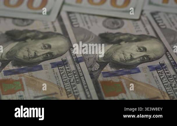 Macro view of multiple one hundred dollar bills arranged in a pattern ...
