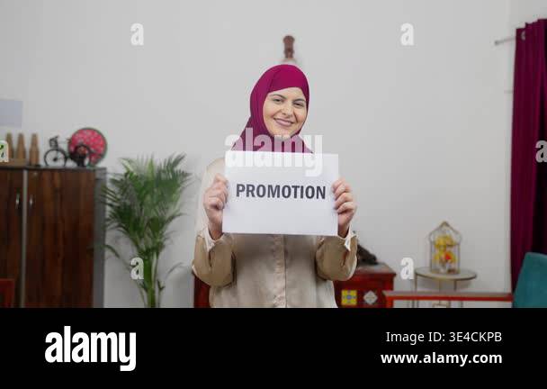 Muslim Woman in Hijab Scarf standing with Promotion Poster Stock Video ...