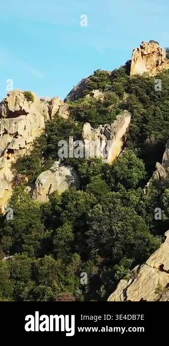 Scenic view of dramatic rocky cliffs and dense green forest in the ...