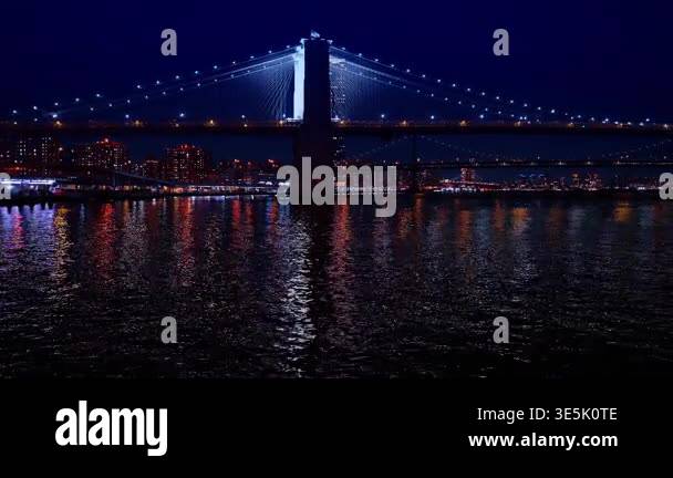 Sparkling river waterscape at night. Low angle view at the Brooklyn ...