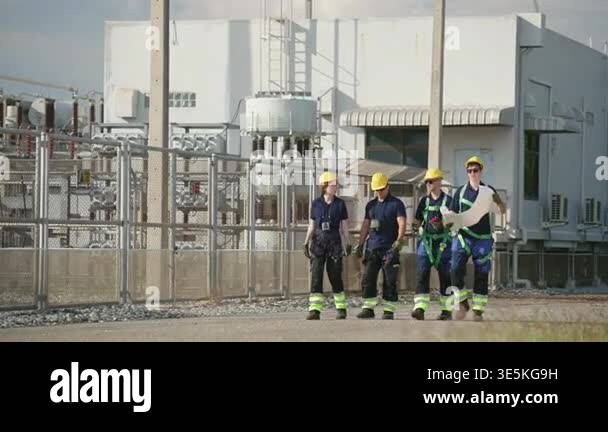 Engineers working on site in electricity substation. Technician wearing ...