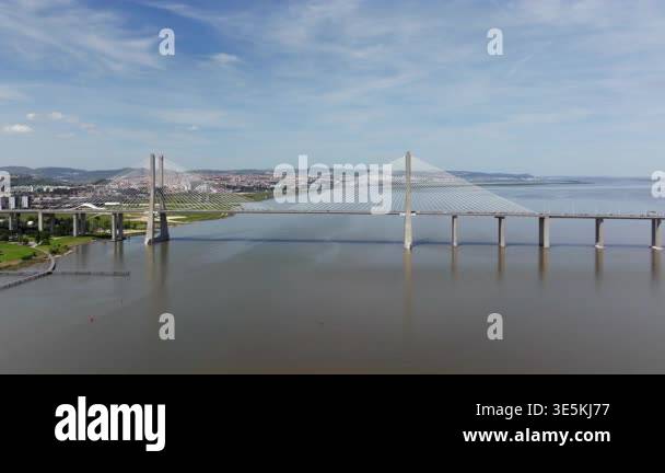 Aerial drone footage shows the majestic Vasco da Gama Bridge spanning ...