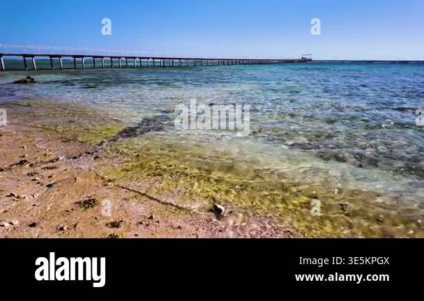 Red Sea coast wooden jetty leading to the diving area on the coral reef ...