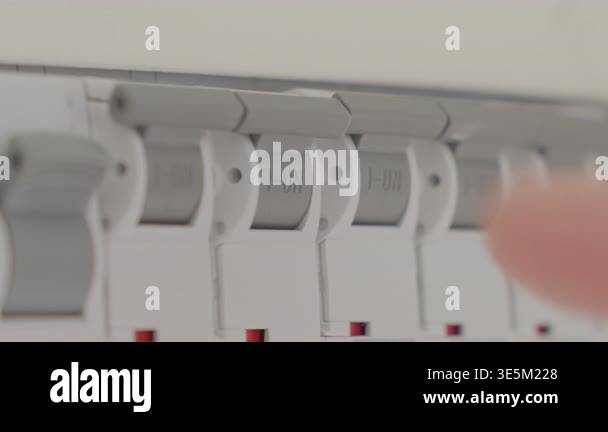 Hand switching circuit breaker in electrical distribution panel ...