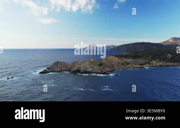 Aerial view of a rugged coastline with a historic Genoese tower ...