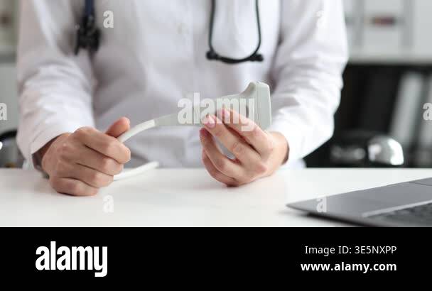 Doctor holds ultrasound probe preparing device for diagnostic scan at ...