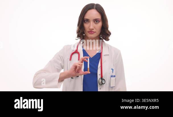 Woman doctor holds cigarette between fingers shaking head on white ...