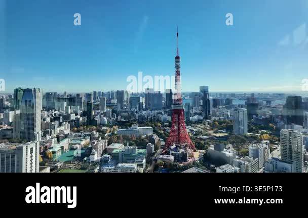 Aerial view of Tokyo Tower surrounded by tall buildings under clear ...