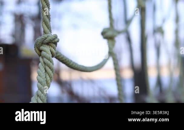 A complex knot of thick ropes, which is part of the structure of a rope ...