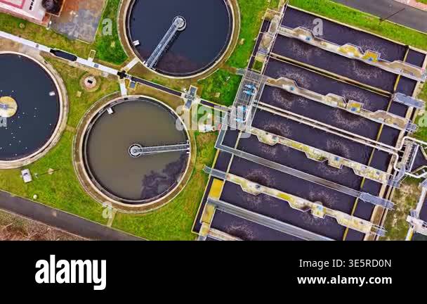 Aerial view of a wastewater treatment plant displaying circular and ...