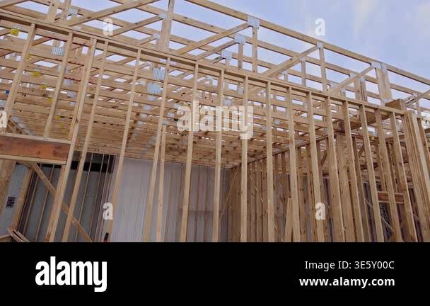 Workers build wooden trusses frame for new structure at construction ...