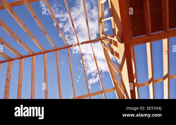 Workers are building wooden roof installing joists, roofing stick frame ...