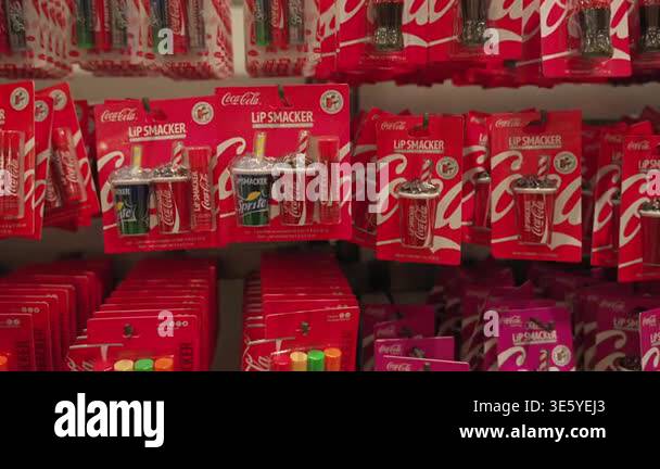 Close view of Coca Cola themed lip balm products on retail display ...