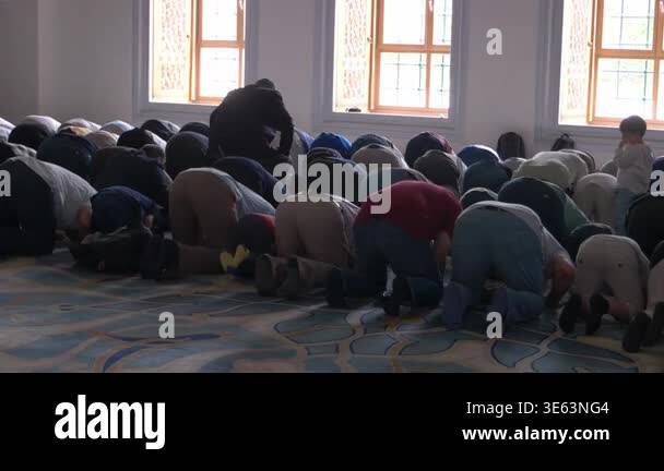 Large group of Muslim worshippers performing prostration during prayer ...