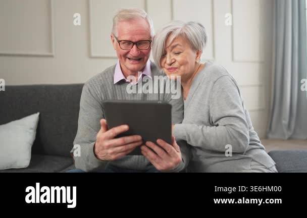 Senior old couple with tablet watching video online. Husband wife ...