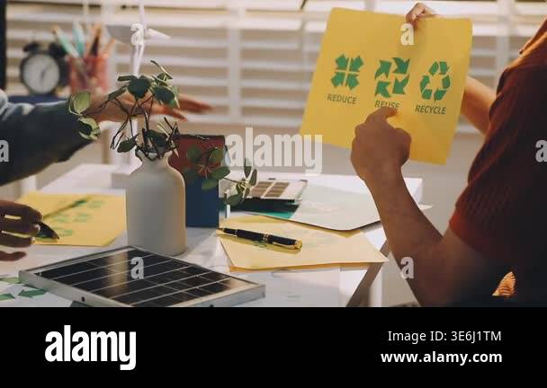 close up of woman holding green energy leaf and showing sign on paper ...