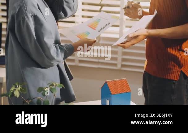 real estate agent showing house model of house and customer Stock Video ...