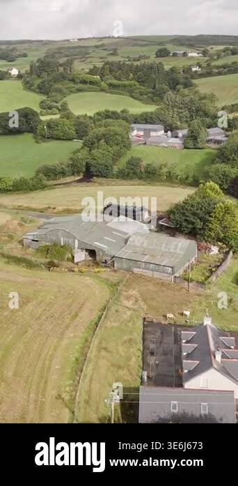 Overlooking lush green rolling hills and traditional farmhouses nestled ...