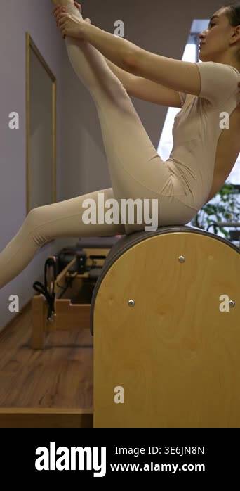 Portrait of woman with pilates trainer doing exersices on the Ladder ...