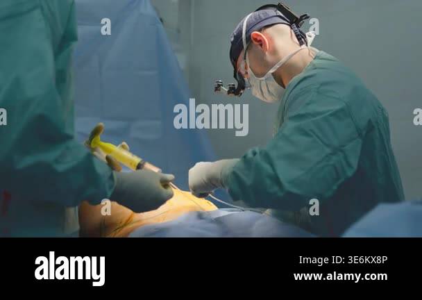 Professional surgeon doing medical operation in sterile hospital clinic ...