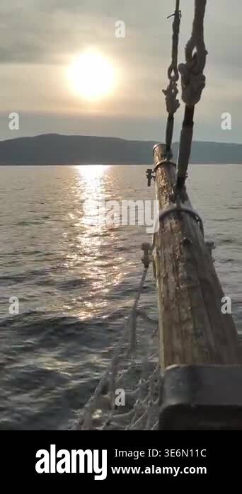 Sunset reflection on wooden boat nose, sailing on fast speed. High ...