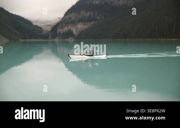 Banff, Canada - 27 apr 26: Majestic scenery of Lake Louise with a man ...