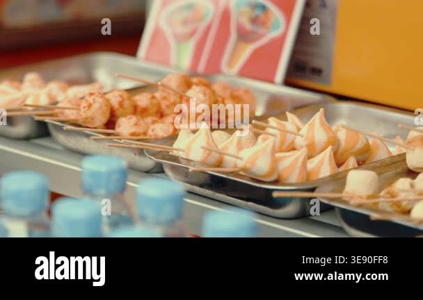 Panning shot of various skewered processed foods like fish balls and ...