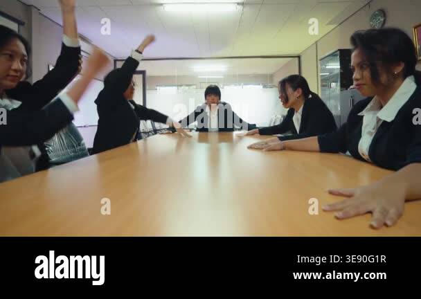 A group of female professionals in business suits take a fun break ...