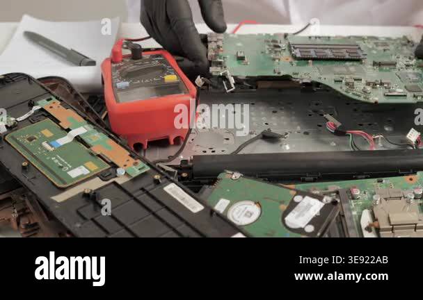 Disassembled electronic device components on workbench, close up view ...