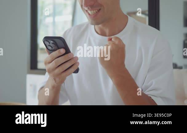 Good news man reacts with excitement while reading smartphone message ...