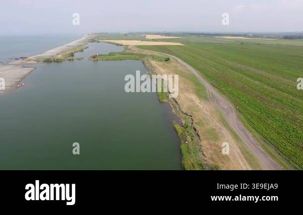 Aerial view of coastal lake and sea lagoon with sandbar and farmland ...