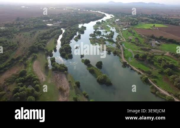 Aerial Nile River in Egypt winding through green farmland and wetlands ...