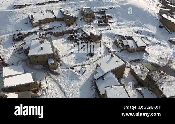 Aerial snowy traditional poor village houses across rural Afghanistan ...
