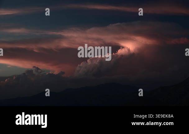 sunset timelapse rain thunderstorm dusk distant hills cumulus cloudbank ...