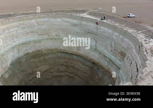 Deep sinkhole cave in aerial drone view as research team rappelling ...