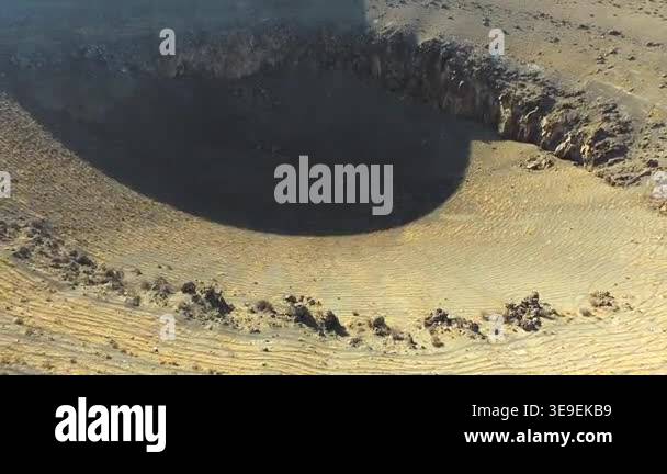 Aerial drone massive sinkhole formed by underground collapse in barren ...