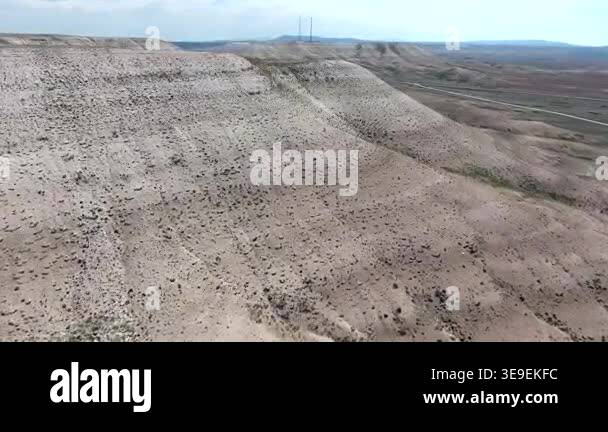 aerial badlands desert valley limestone hills soil terrain gullies ...