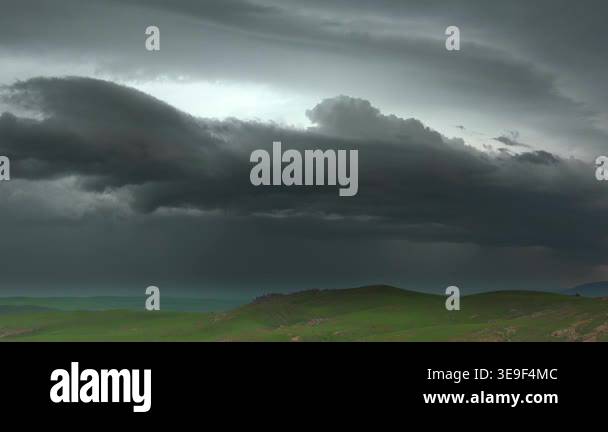 Storm clouds approach Kazakhstan steppe before rain under a dark sky ...