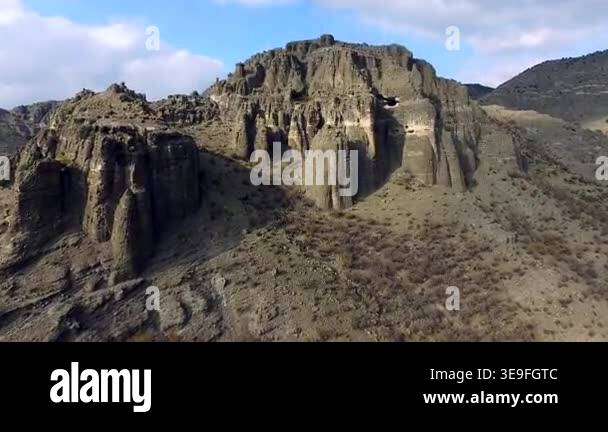 Aerial drone view of ancient rock cut cave houses atop treeless ...